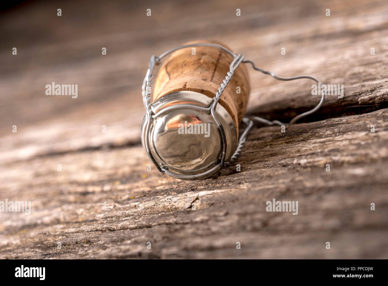 Champagne cork with attached wire and metal cap lying on old weathered ...