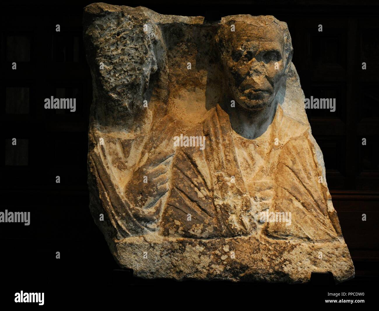 Roman funerary relief depicting a freed slave and his wife. Portrayed ...