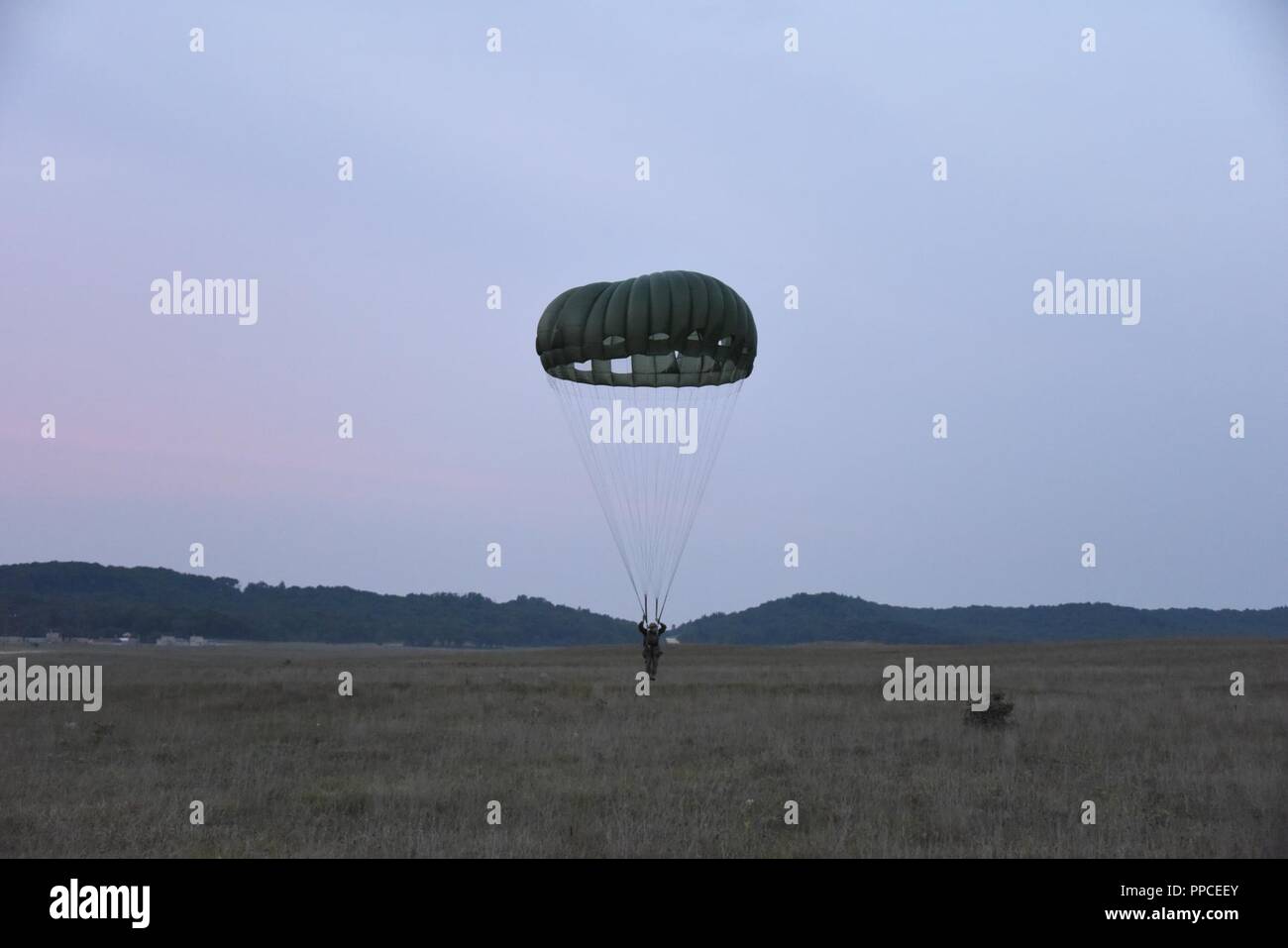 Marines perform a static line jump from an AC-130 at Fort McCoy, Wis ...