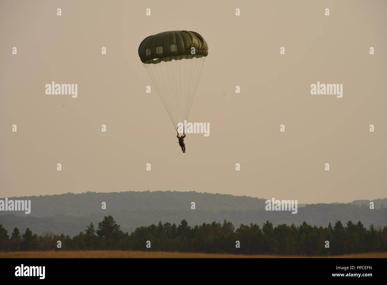 Marines perform a static line jump from an AC-130 at Fort McCoy, Wis ...