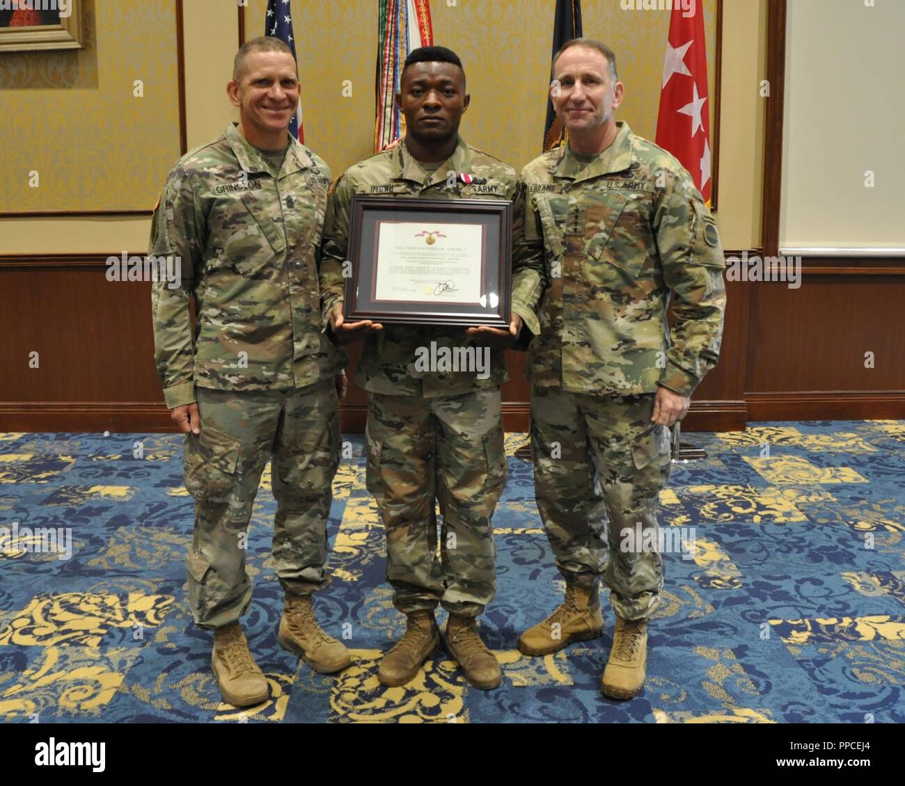 Staff Sgt. Ifegwu Ifegwu, center, receives the Meritorious Service ...