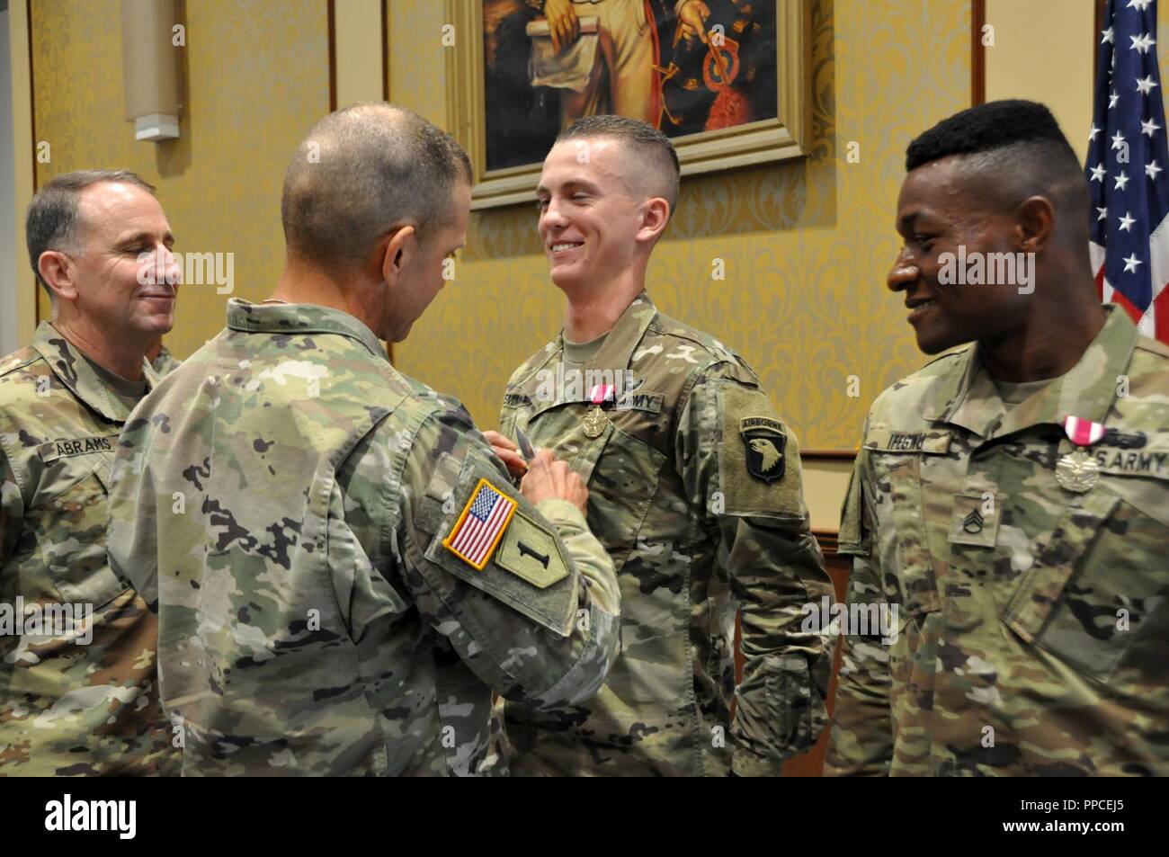 Pfc. Caden J. Emmons, center, is promoted to specialist by Command Sgt ...