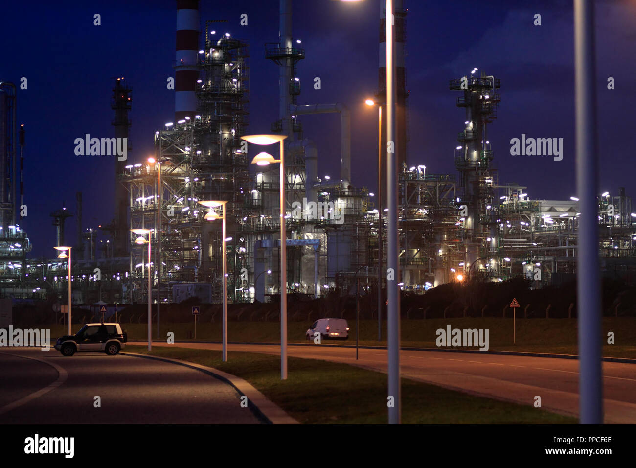 Oil refinery near a road at night Stock Photo - Alamy