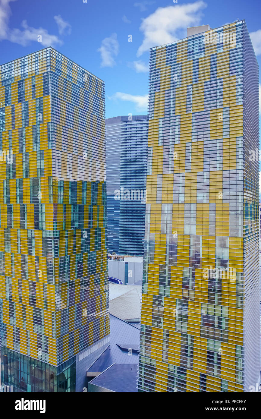 Two modern yellow and silver towers rising into the sky Stock Photo - Alamy