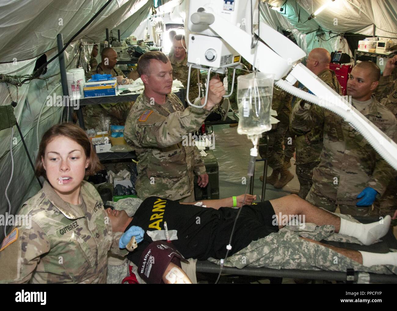 Soldiers with the 131st Field Hospital, 528th Hospital Center, assess a ...