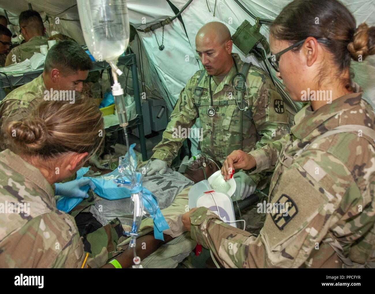 Soldiers with the 131st Field Hospital, 528th Hospital Center, assess a ...