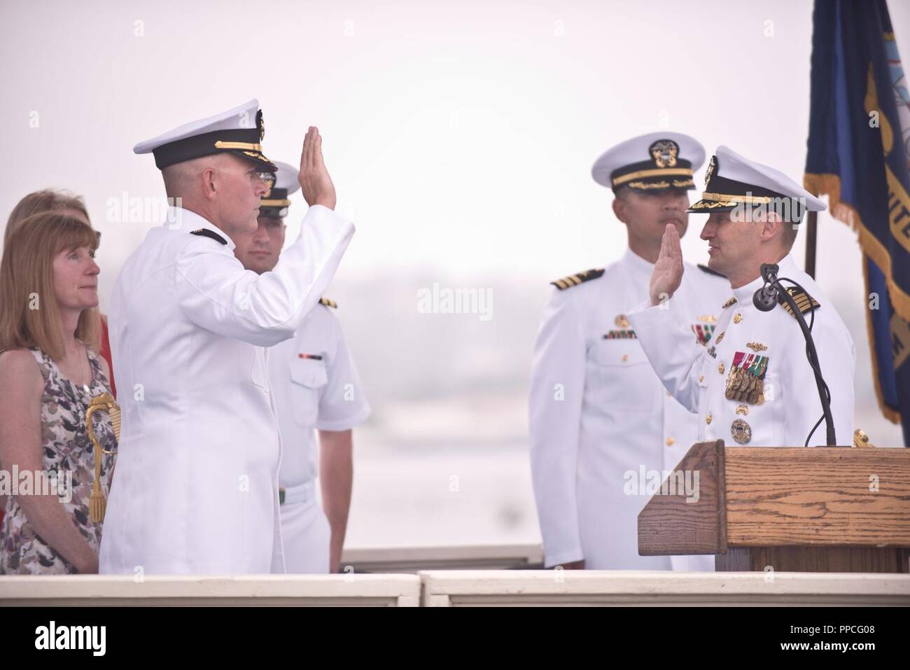 SAN DIEGO (Aug. 24, 2018) Capt. Chris Cavanaugh (right) administers the ...