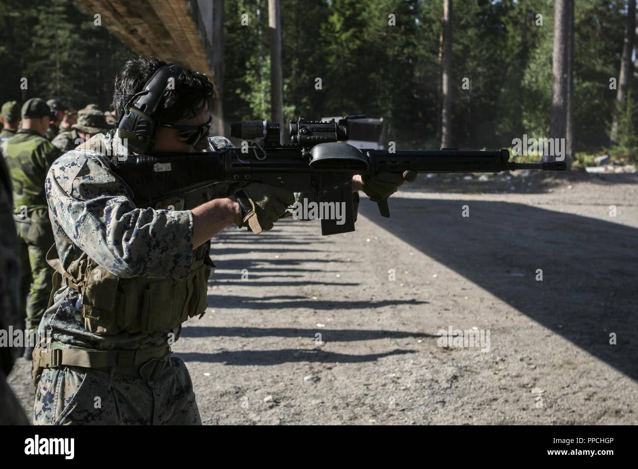 A U.S. Marine with Marine Rotational Force-Europe 18.1 shoots the ...