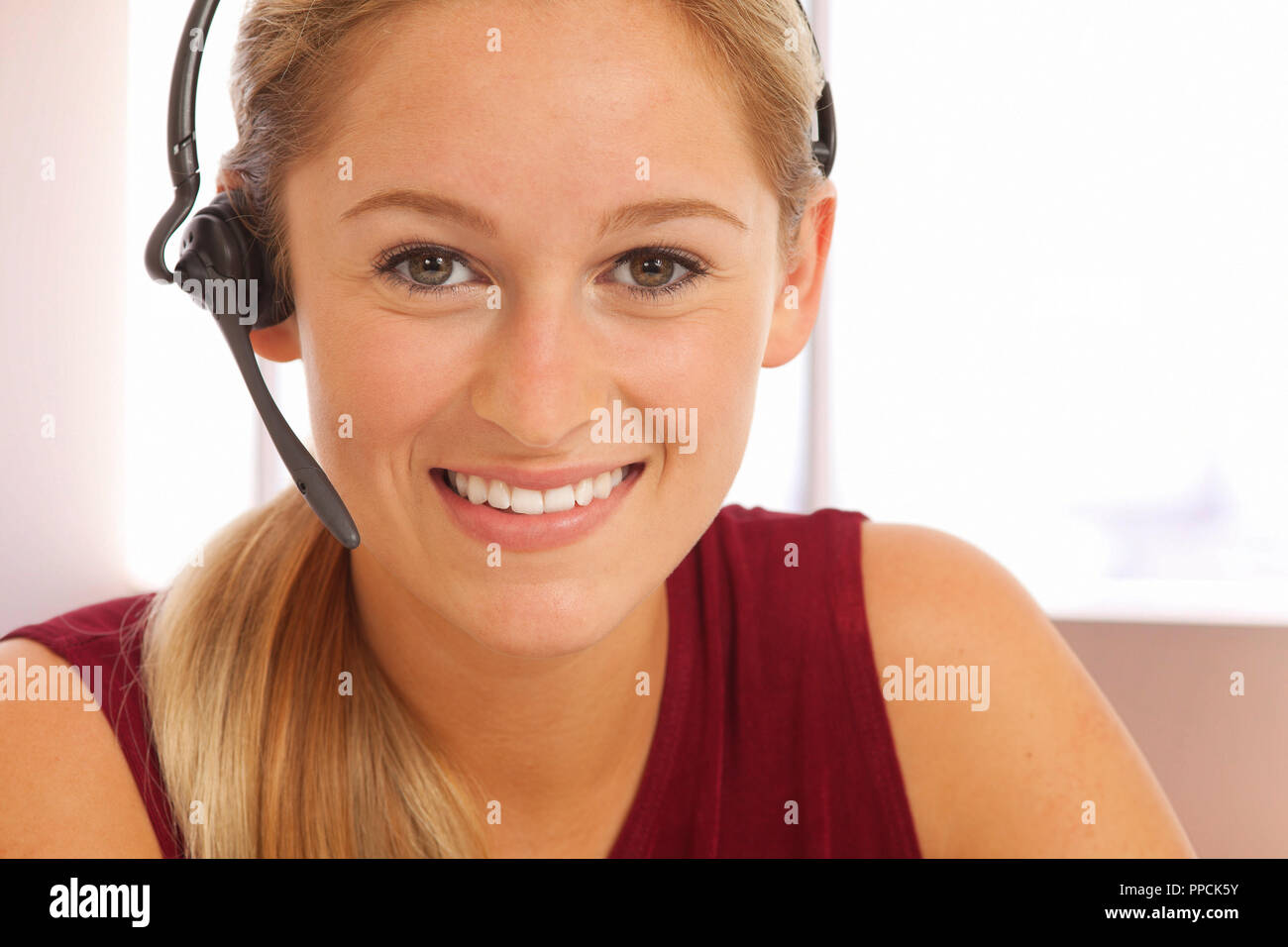 Portrait of young telemarketer inside office building Stock Photo - Alamy
