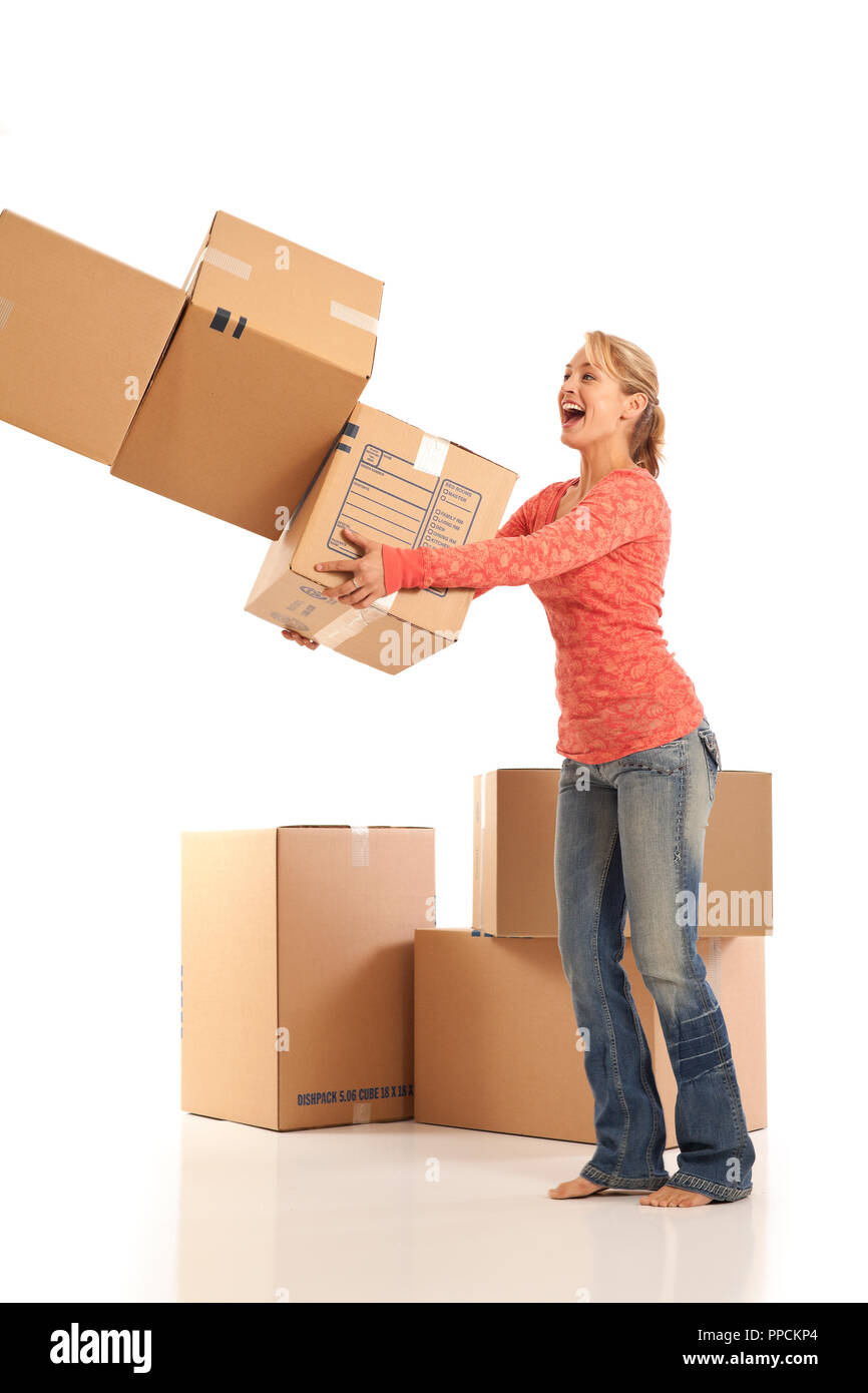 Young woman dropping cardboard boxes Stock Photo - Alamy