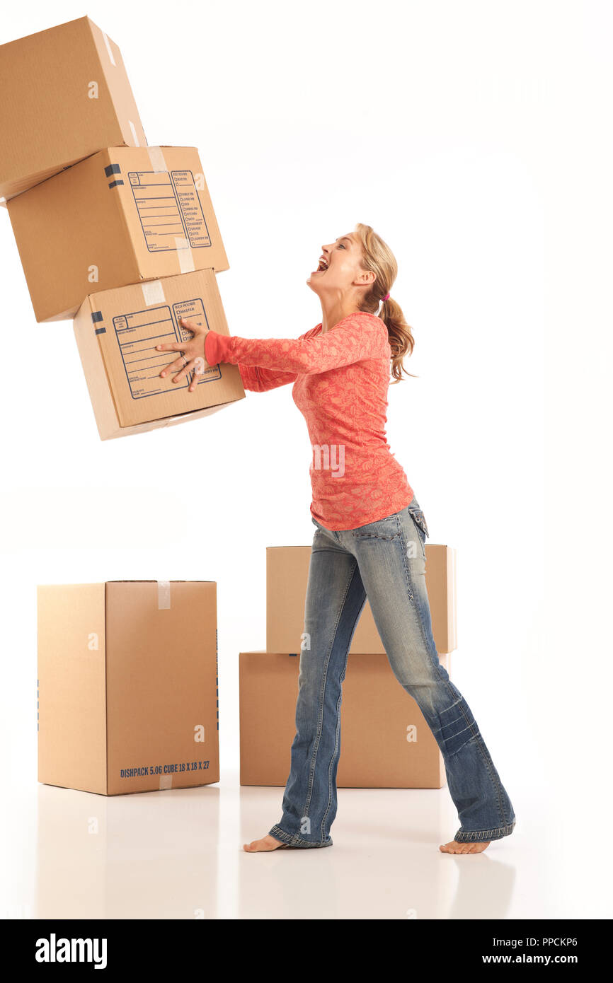 Young woman dropping cardboard boxes Stock Photo - Alamy
