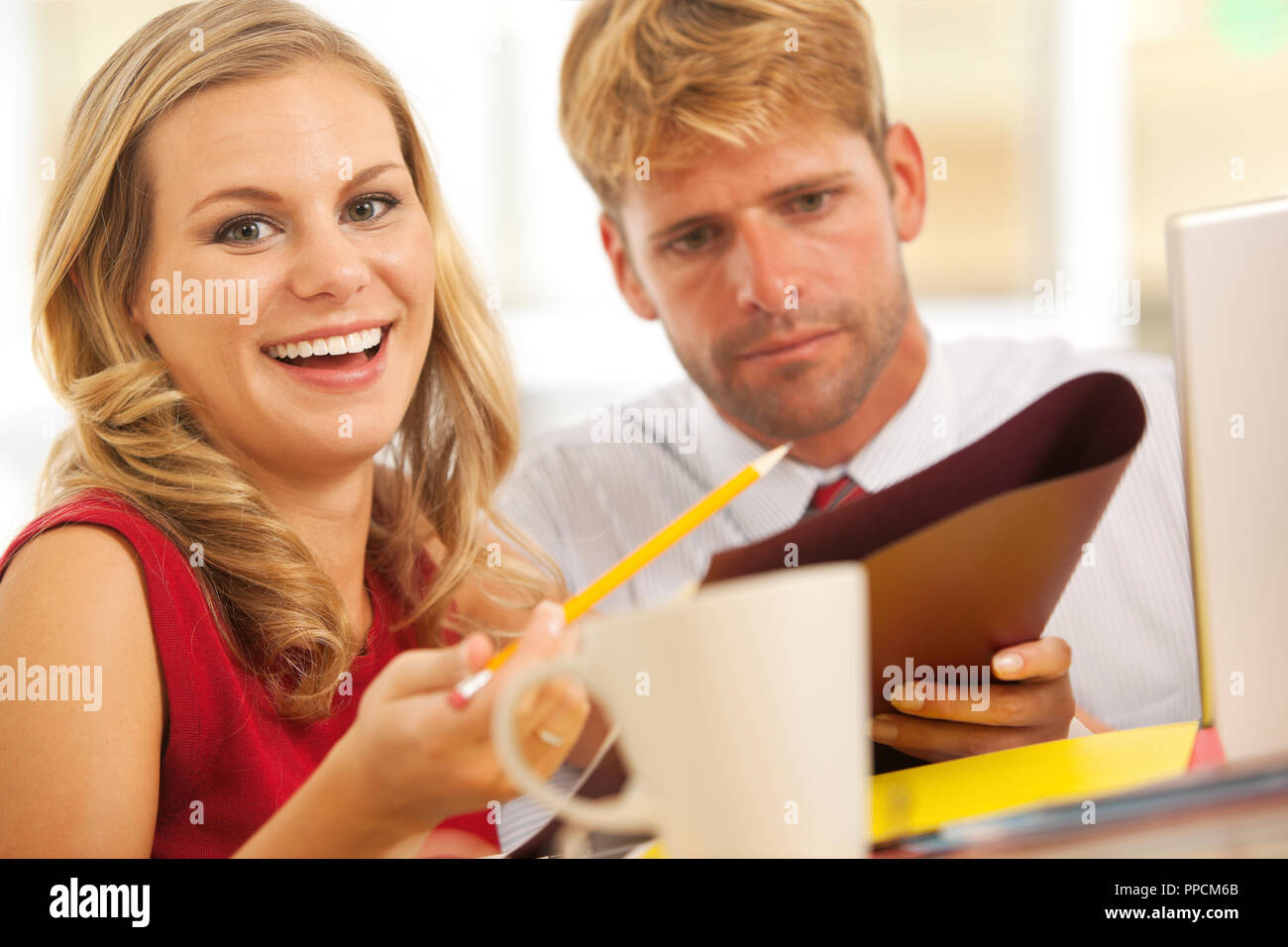 Business colleagues going over paperwork inside office building Stock ...