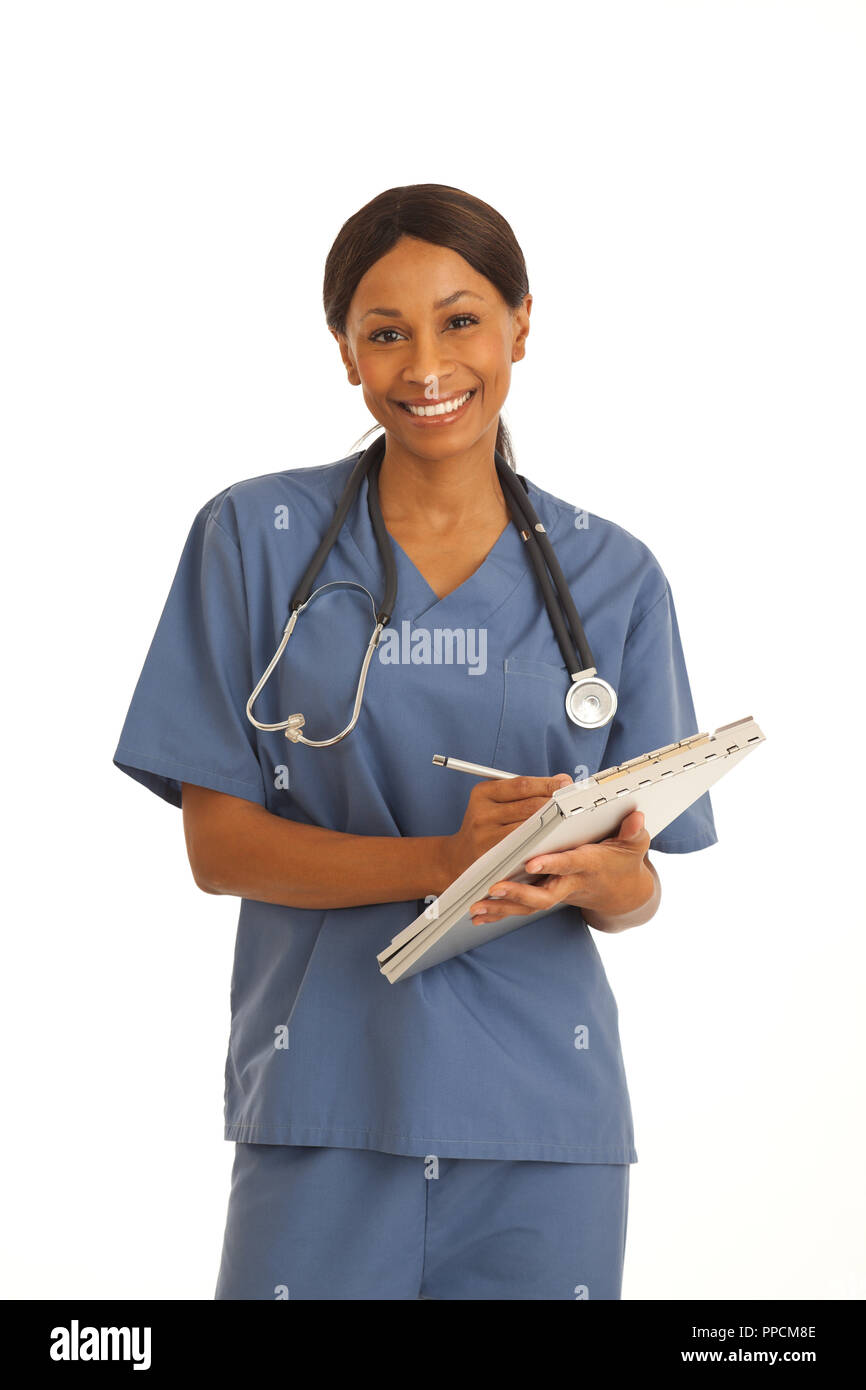 Young professional doctor wearing scrubs and using clipboard to write ...