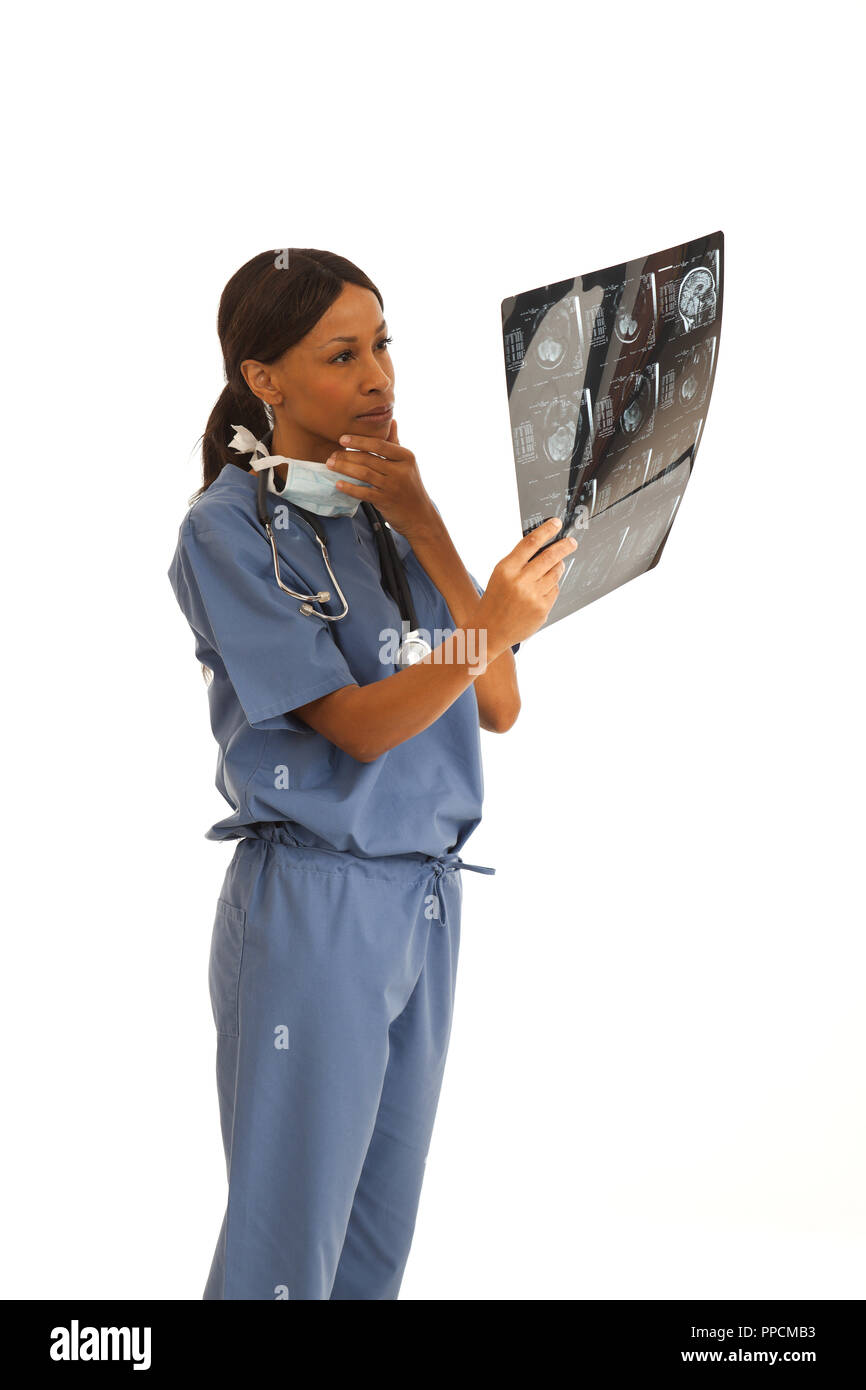 Professional female African doctor examining ct-scan of patients brain ...