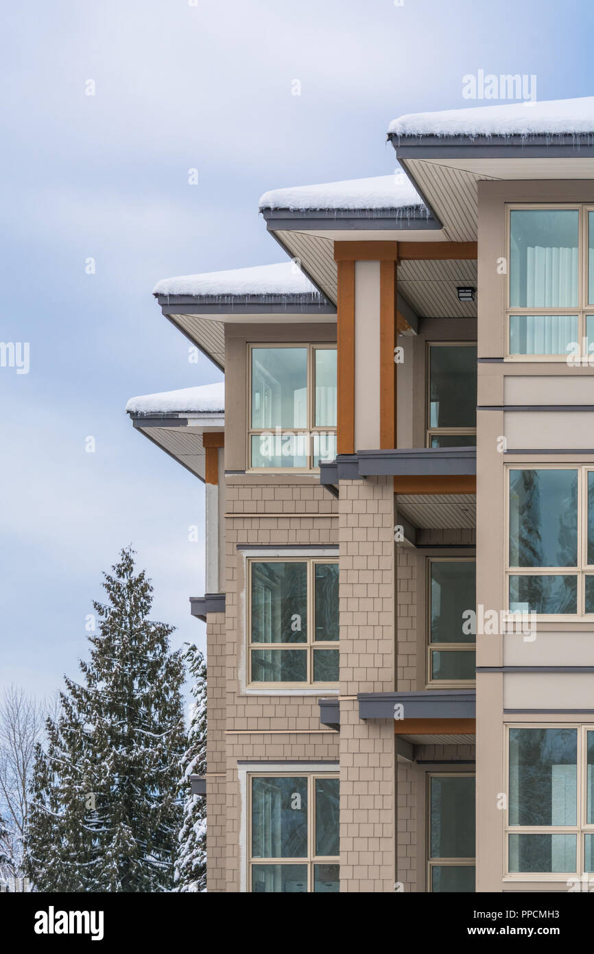 Four corners of new low rise condo building on winter cloudy day in ...