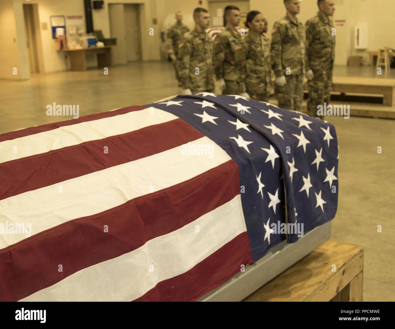 A New York Army National Guard training casket waits on a makeshift ...