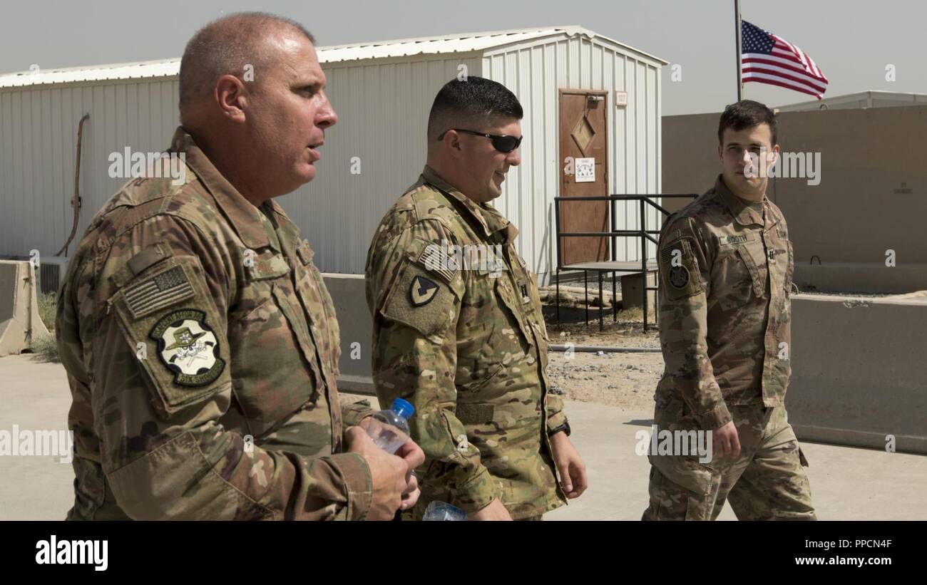 U.S. Army Capt. Joshua Paille, middle, commander of Headquarters and ...