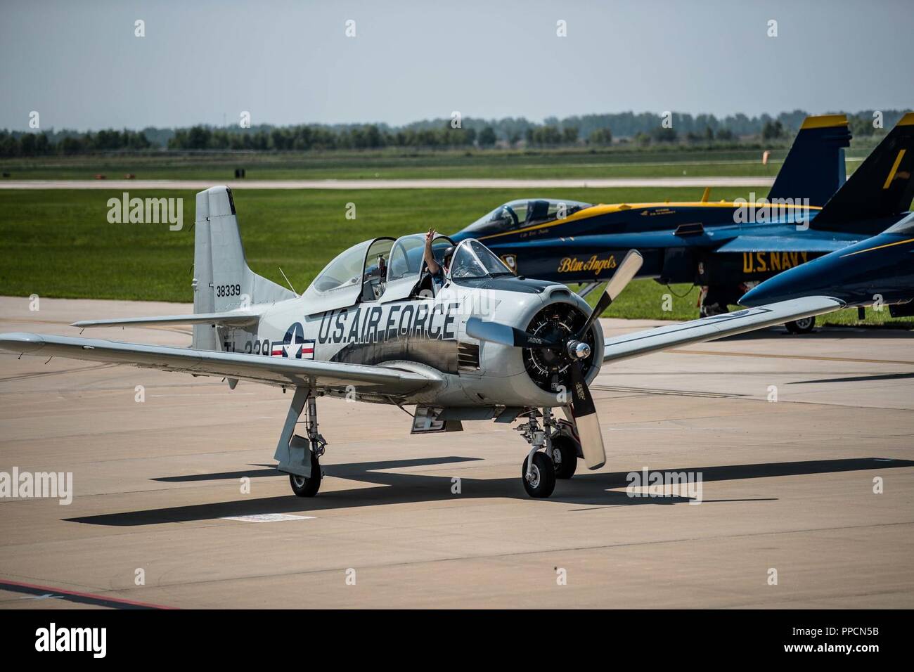 The T-28 Trojan aircraft taxis across the runway after flying over ...