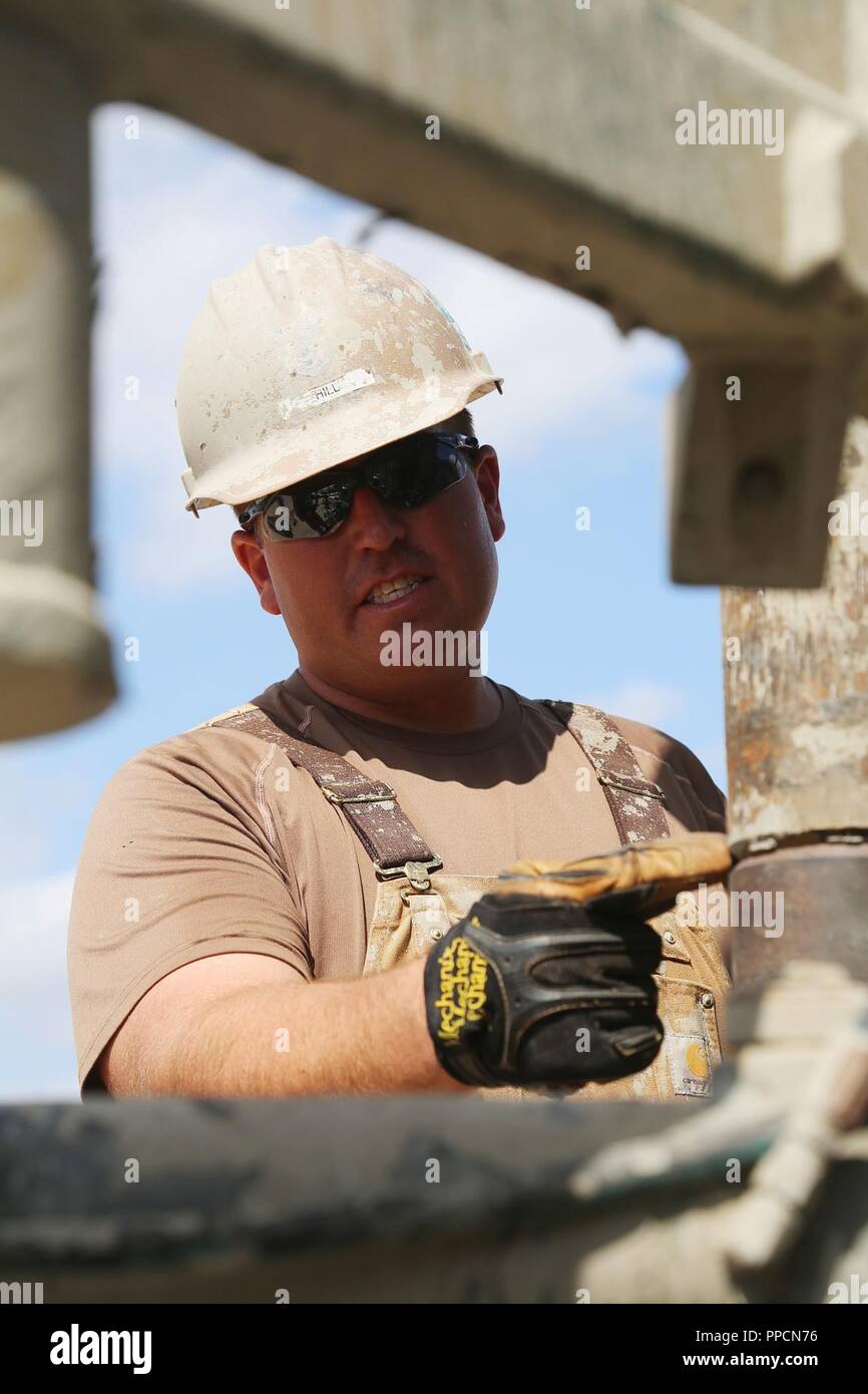 U.S. Navy Equipment Operator 1st Class Dennis Hill, assigned to Naval ...