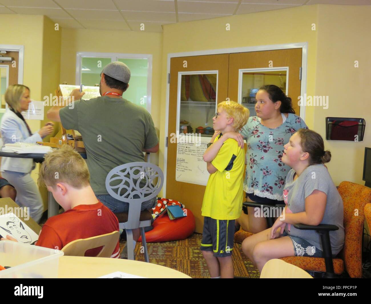 Fort McCoy, Wis., summer campers watch illustrator Jason Gerke, also ...
