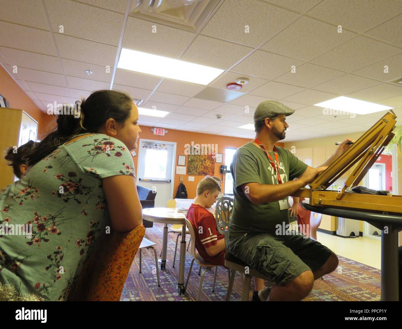 A Fort McCoy, Wis., summer camper watches illustrator Jason Gerke, also ...