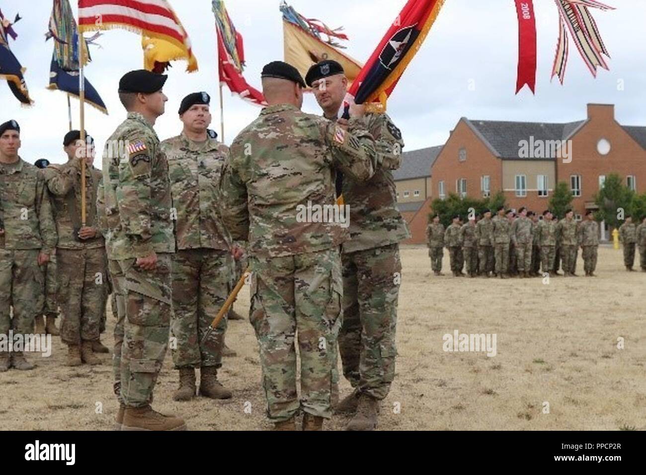 Command Sgt. Maj. Ronald J. Graves passes the Lancer Brigade's Colors ...