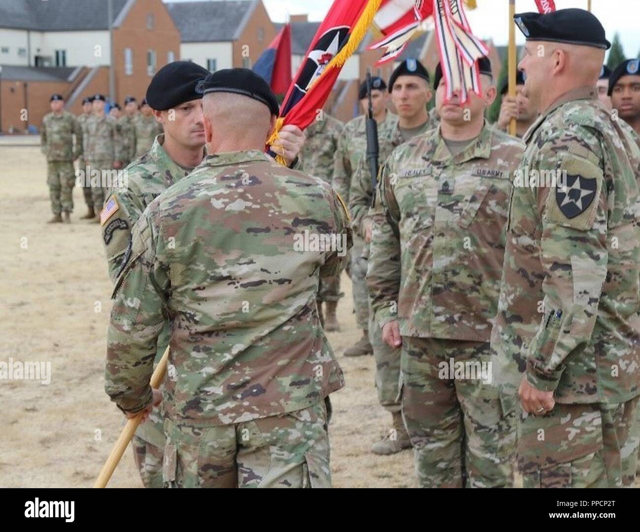 Command Sgt. Maj. Christopher Mullinax accepts the Lancer colors from ...