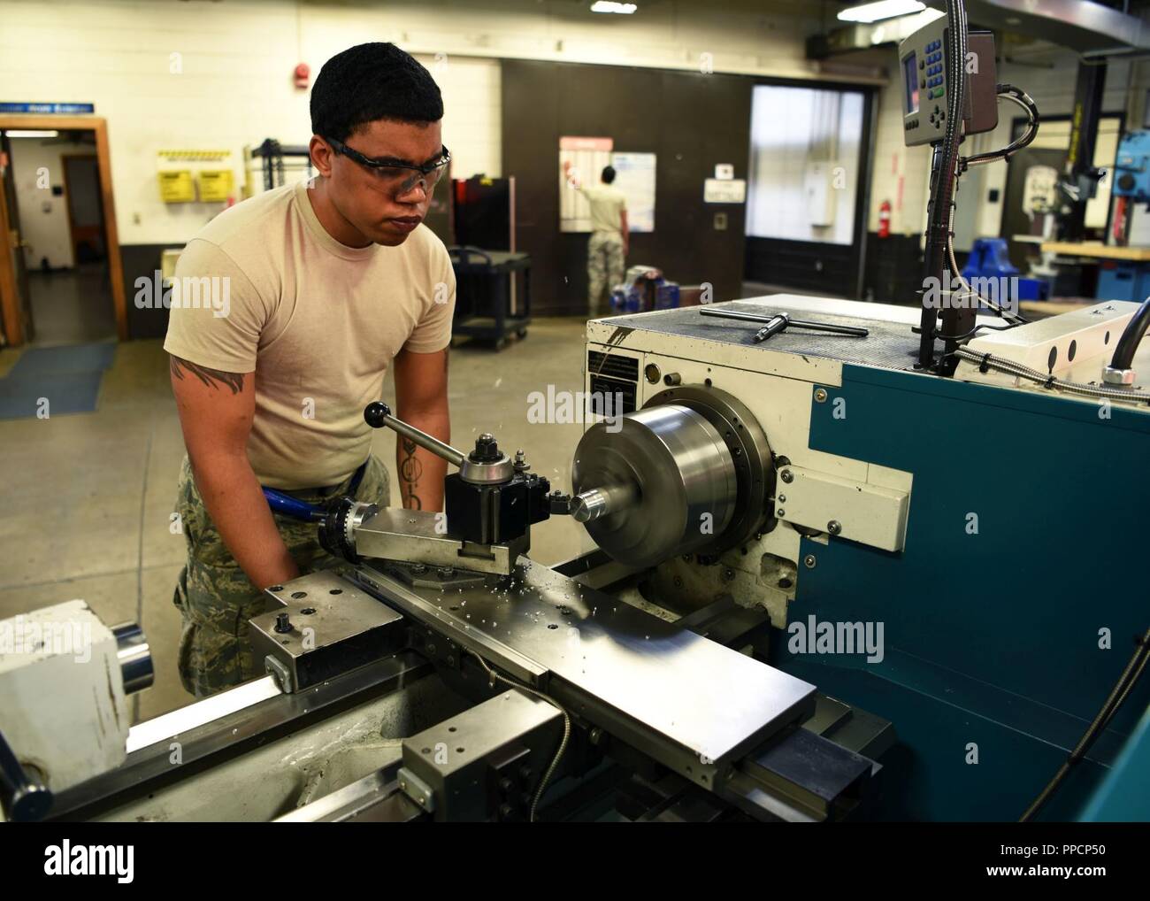 Airman 1st Class Dontie Custis, 5th Maintenance Squadron metals technician, uses an engine lathe ...
