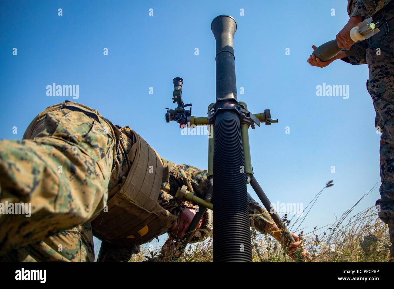 U.S. Marines with Black Sea Rotational Force (BSRF) 18.1 brace the bipod of an 81mm mortar ...