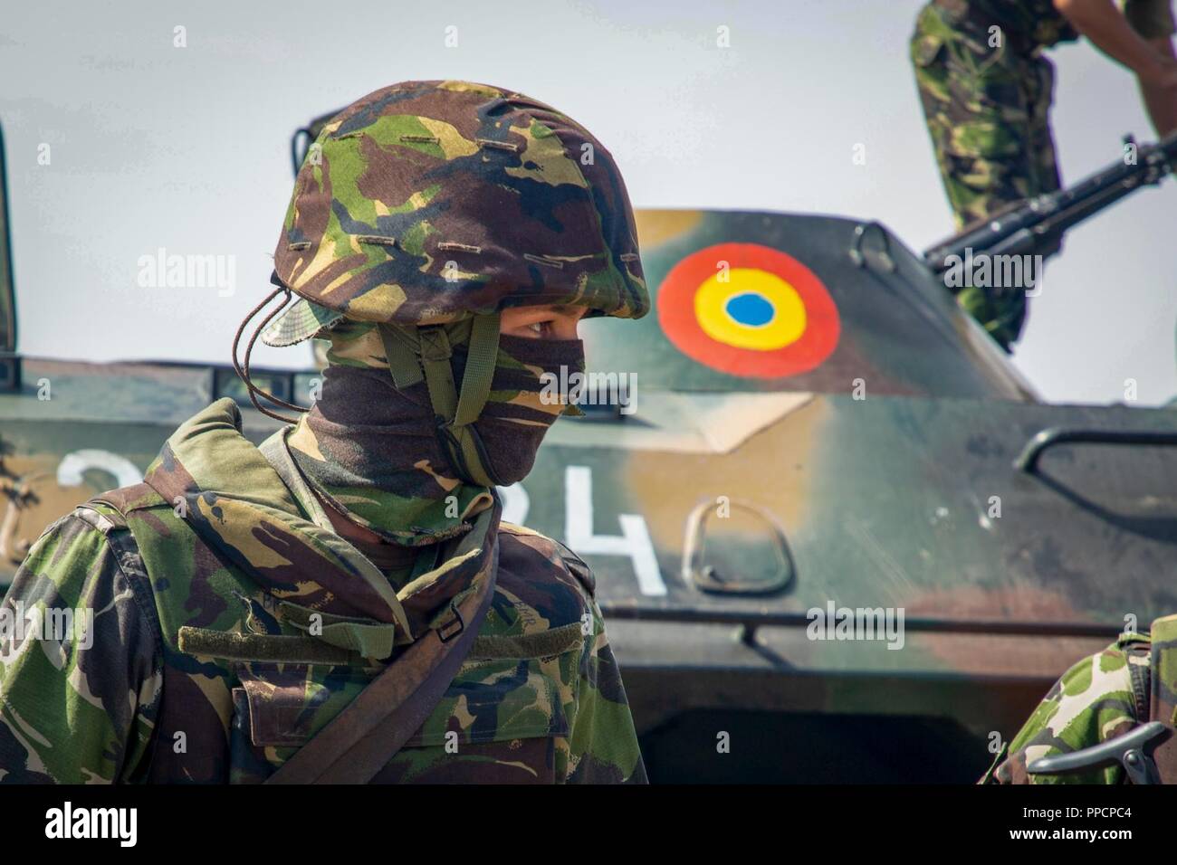 A member of the Romanian Armed Forces prepares to conduct a multi ...