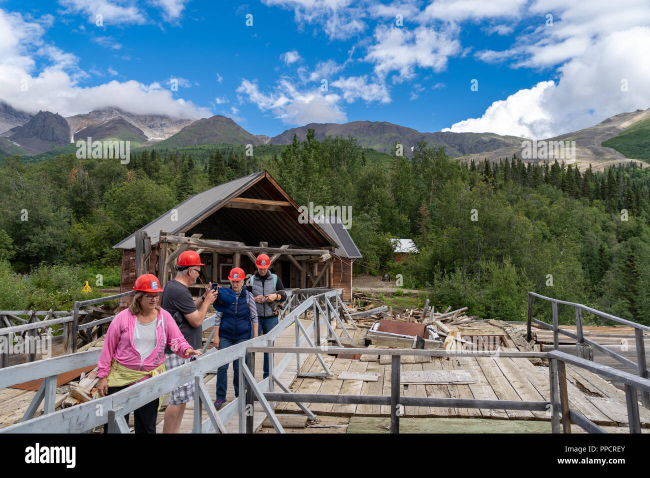 A tour group walks into the abandoned copper mine, Kennecott Mine, for ...