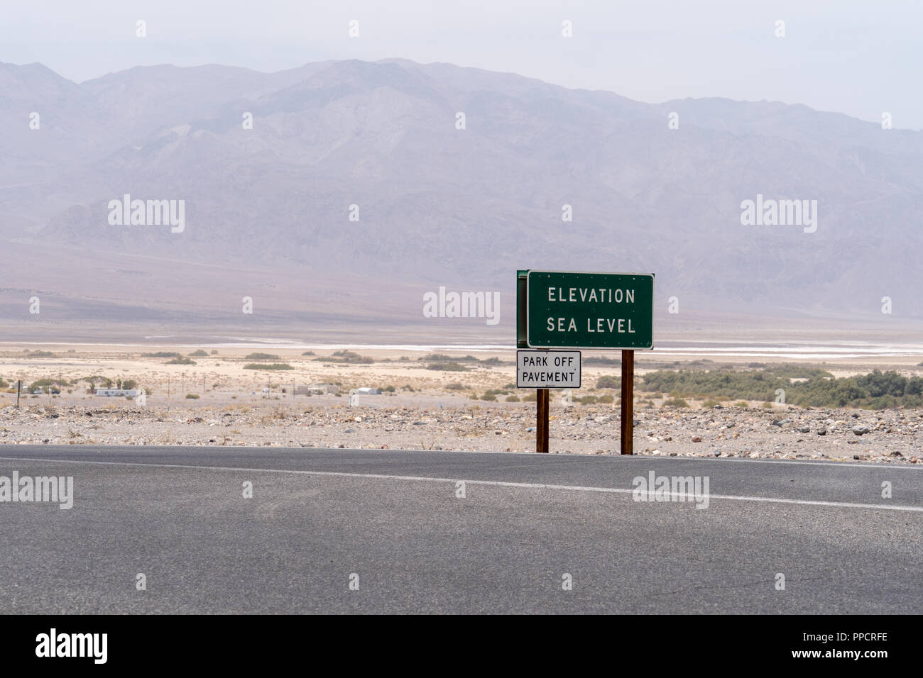 Elevation Sea Level road sign in Death Valley National Park on a hazy ...