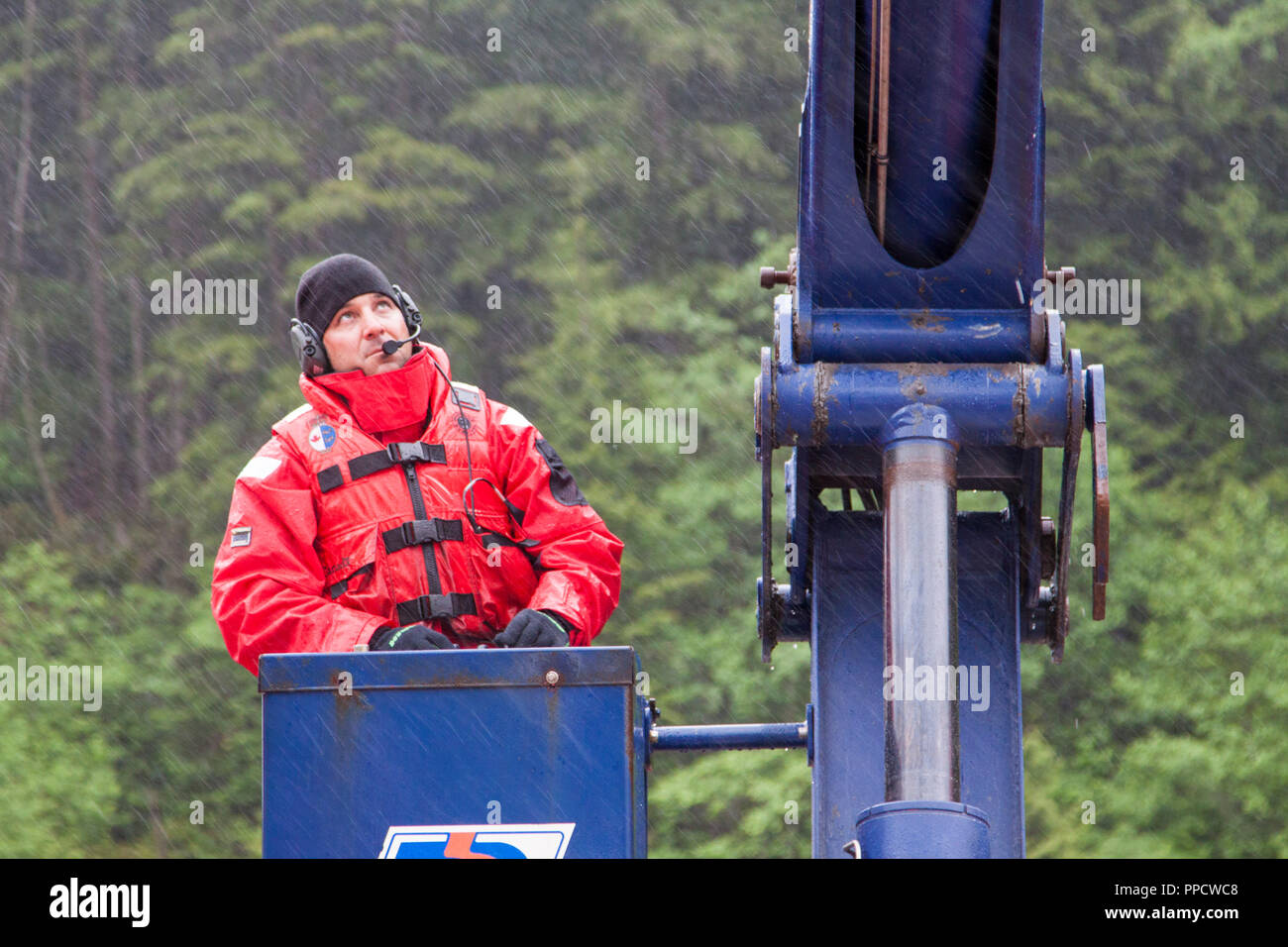 Front view waist up shot of Canadian Coast Guard crew member operating ...