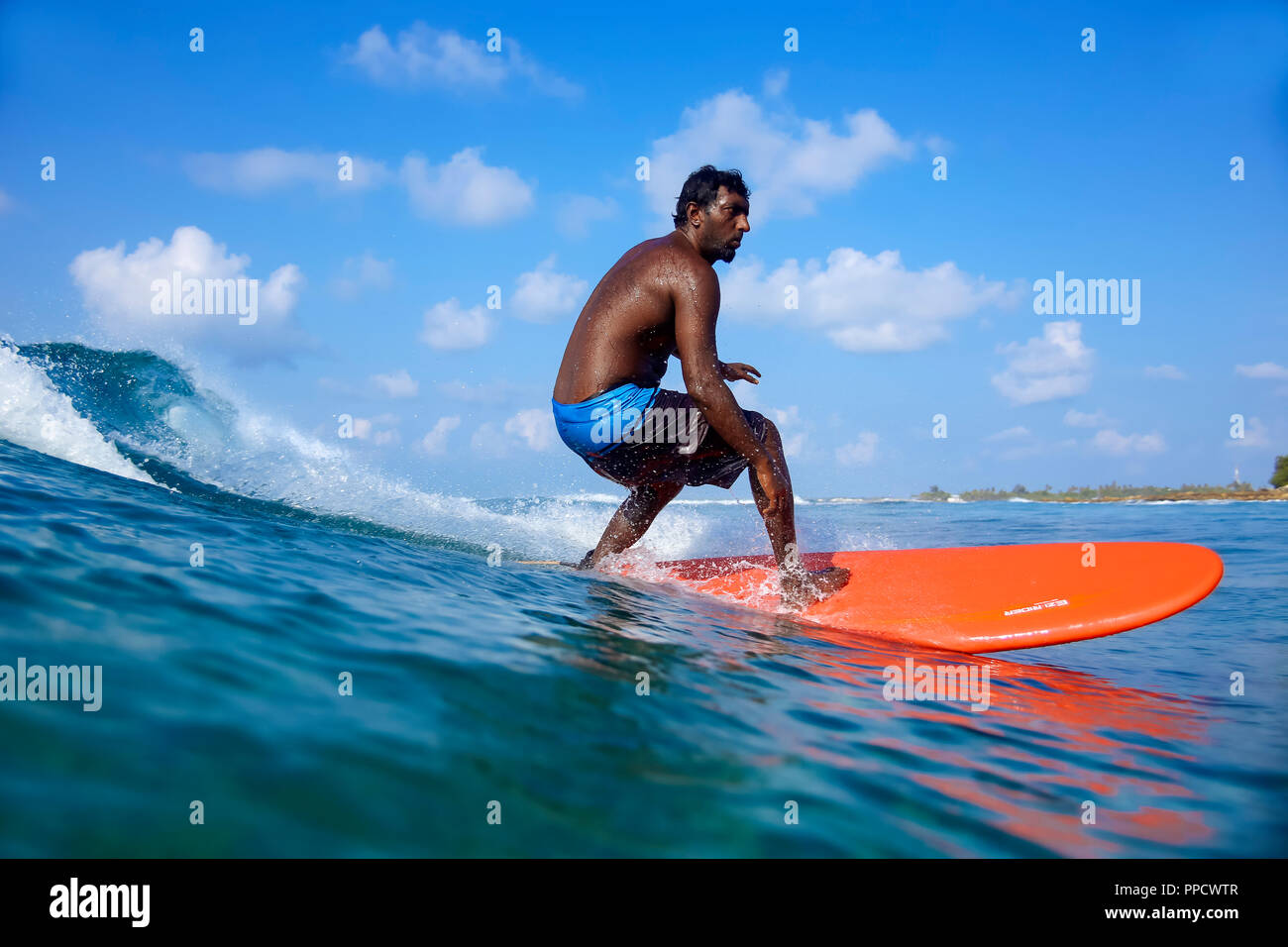 Male shirtless surfer riding wave against sky, Male, Maldives Stock ...