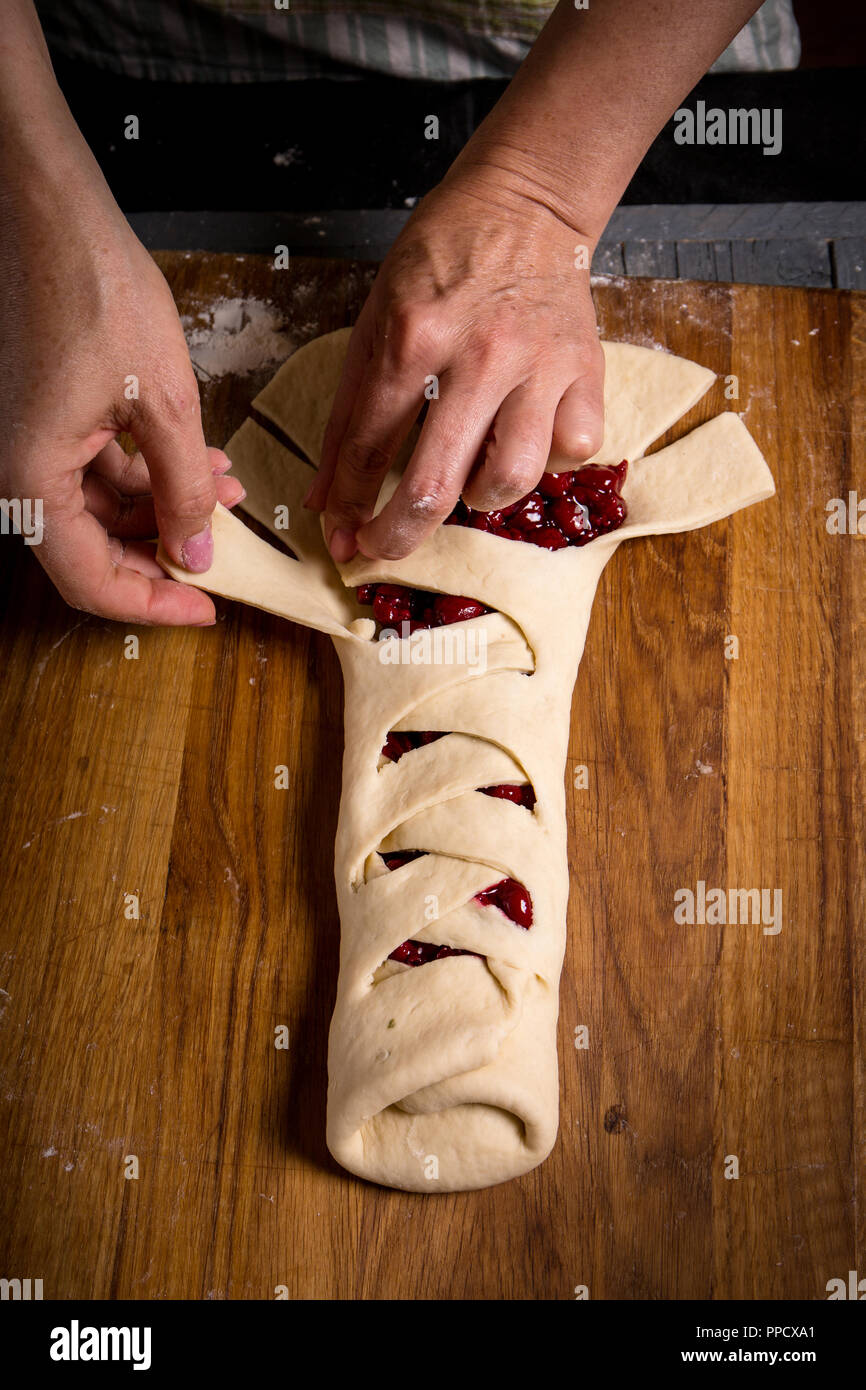 A woman is spinning a roll of dough Stock Photo - Alamy