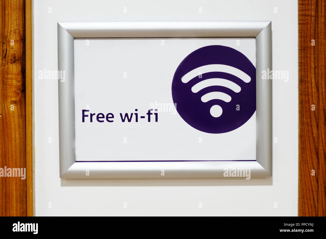 Free wi-fi sign on plain white wall Stock Photo - Alamy
