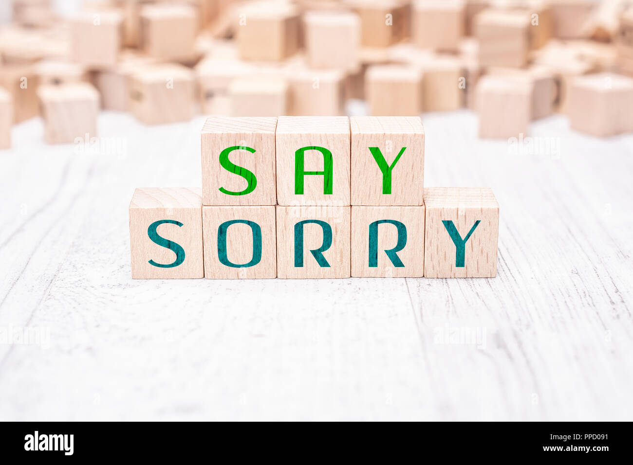 The Words Say Sorry Formed By Wooden Blocks On A White Table Stock ...