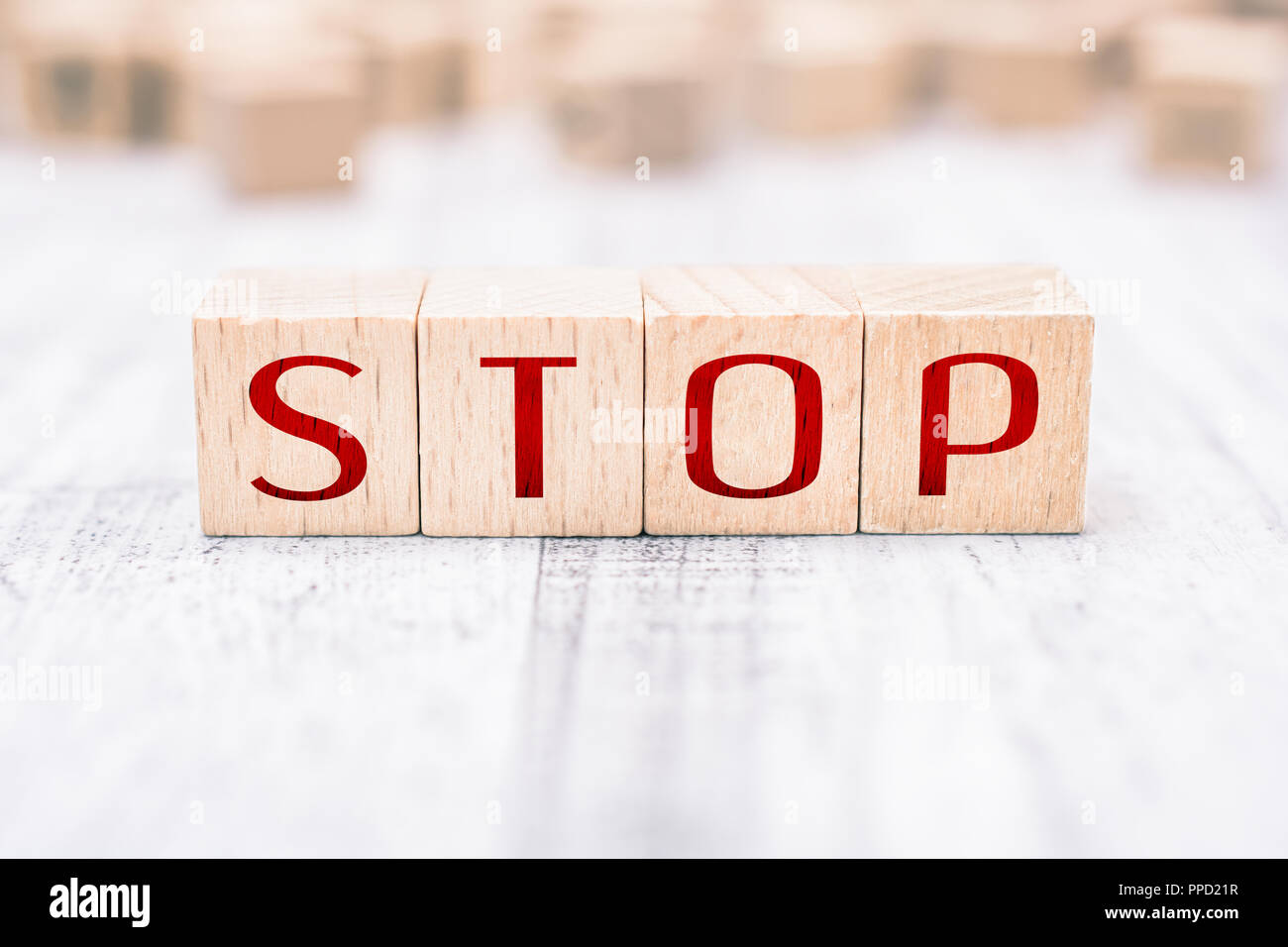 The Word Stop Formed By Wooden Blocks On A White Table Stock Photo - Alamy
