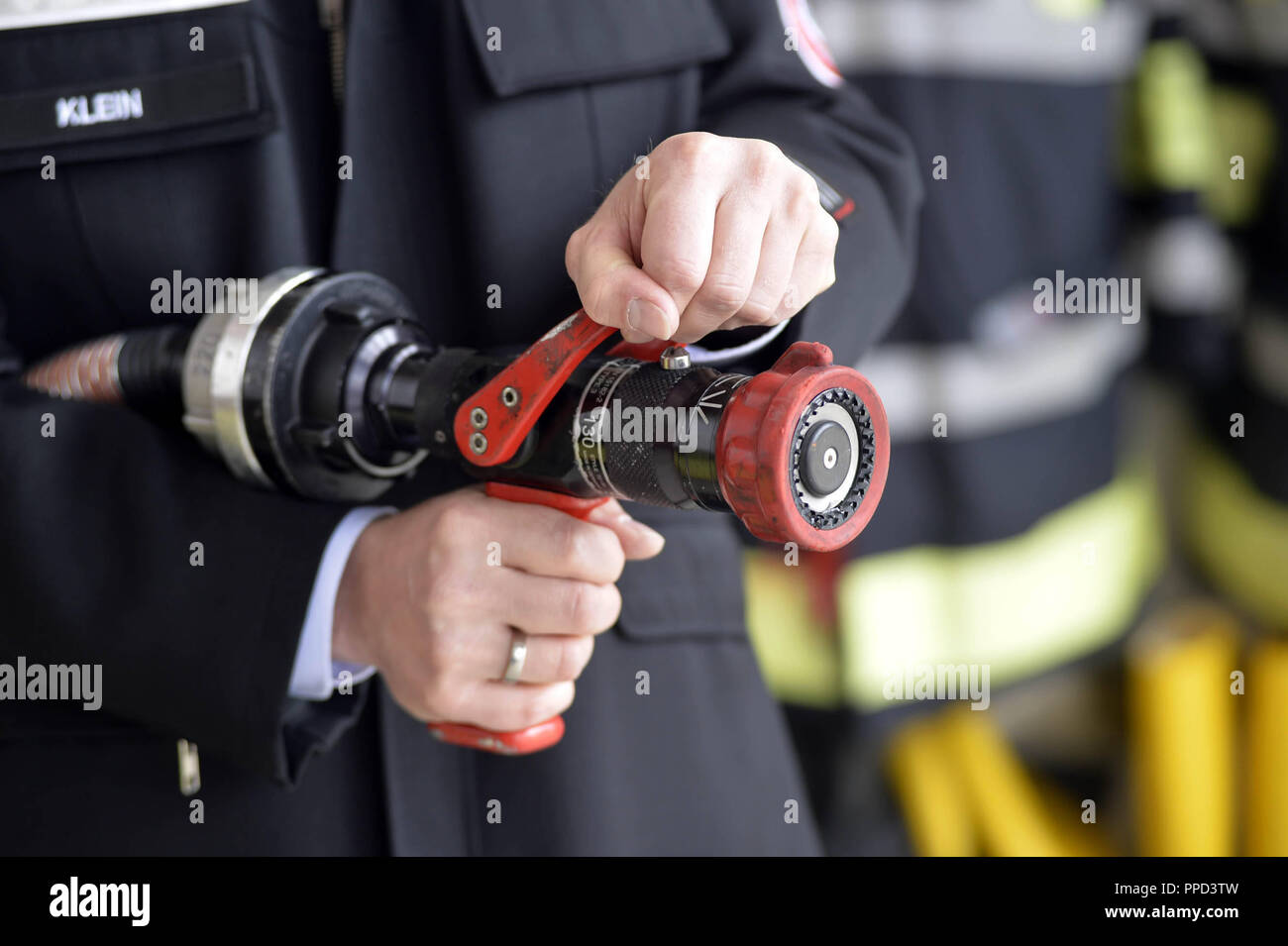 A firefighter of the Volunteer Fire Brigade Michaeliburg with a fog ...