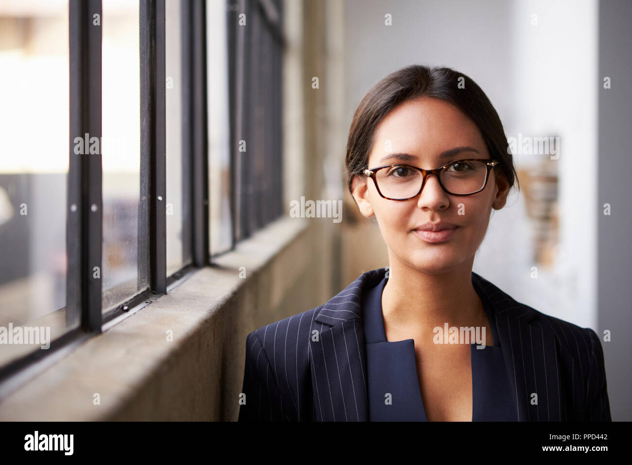 Young mixed race businesswoman wearing glasses, portrait Stock Photo ...