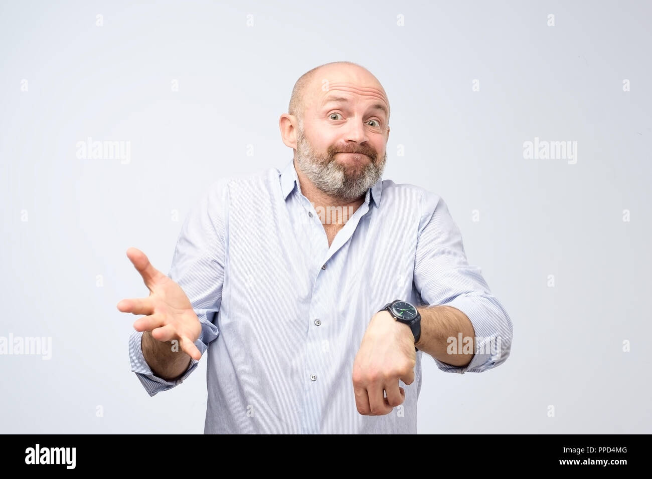 Confused businessman looking watch hi-res stock photography and images ...