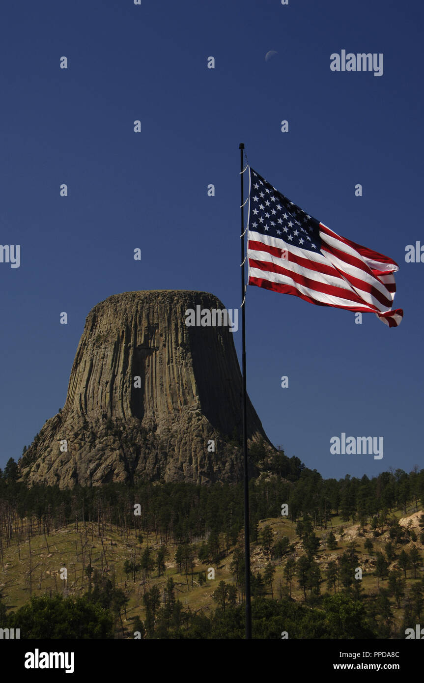 UNITED STATES flag in front of the DEVILS TOWER NATIONAL MONUMENT ...