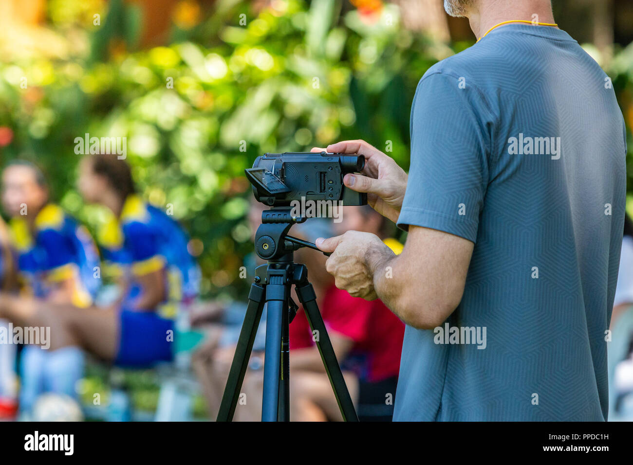 Man recording football match with his video camera on a tripod at an ...