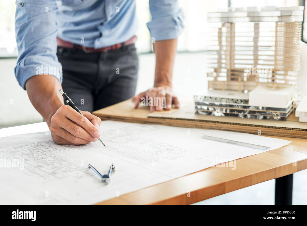 Person's engineer Hand Drawing Plan On Blue Print with architect ...