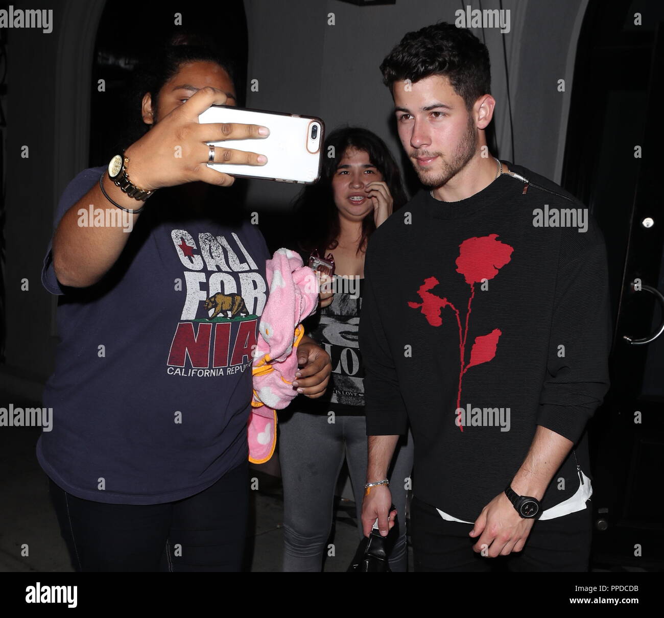 Nick Jonas poses for selfies with fans as he leaves Craig's restaurant ...