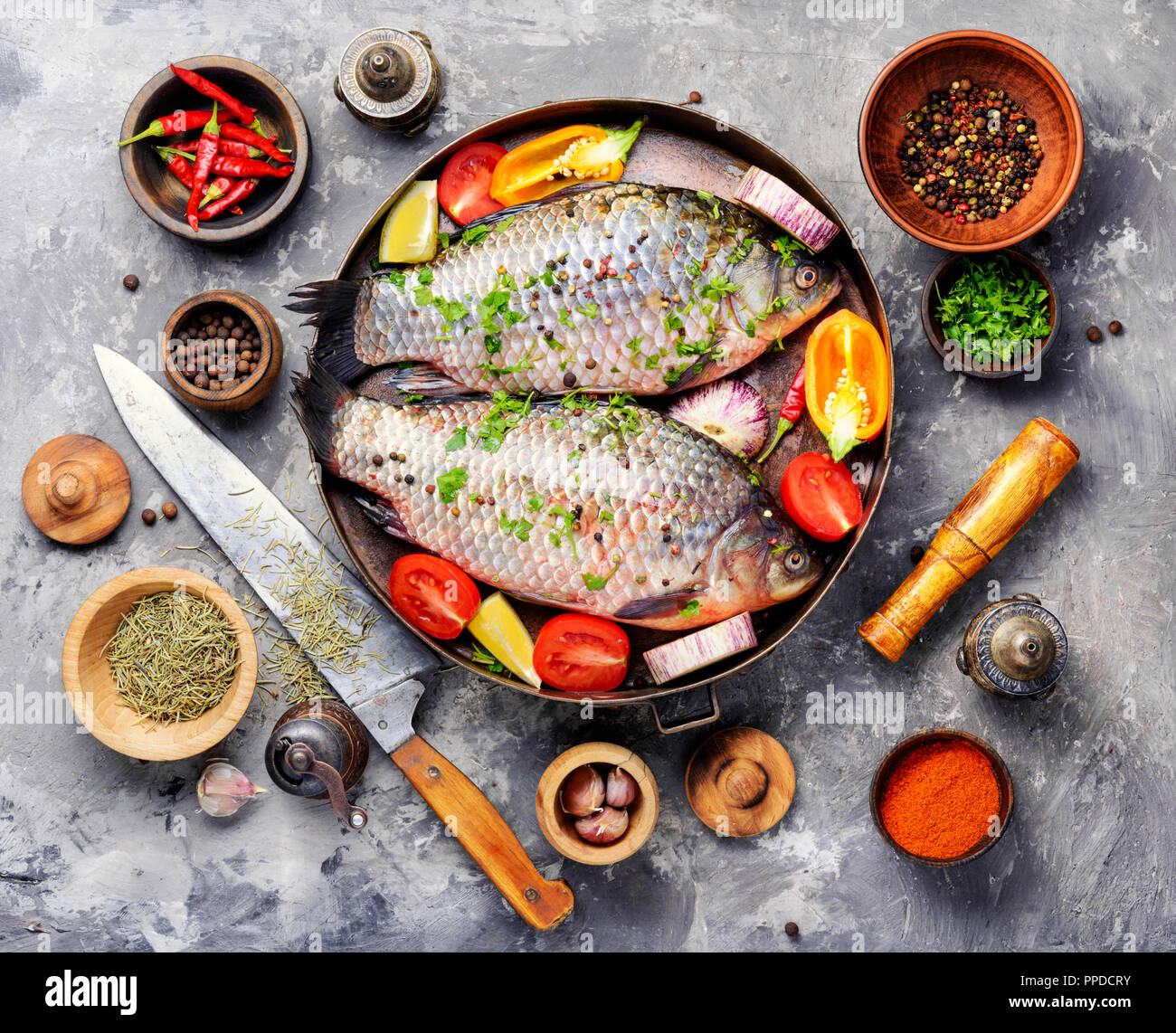 Fresh fish carp with ingredients for cooking on pan.Dietary food Stock ...