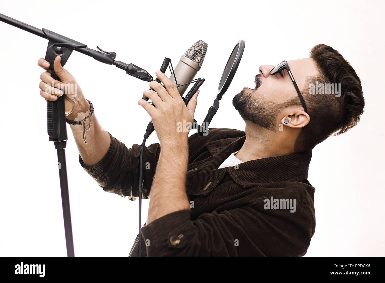 Singer is singing in glasses microphone hi-res stock photography and ...