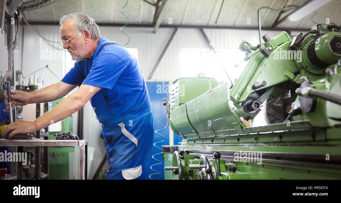 Industrial metal worker working on metal components in factory Stock ...
