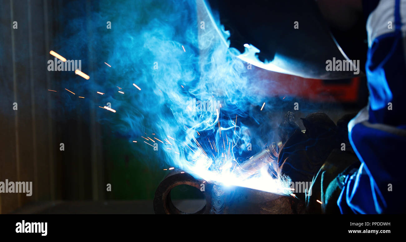 Metal worker welding in metal industry factory Stock Photo - Alamy