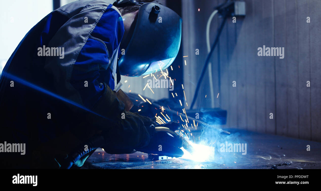 Industrial Worker at the factory welding metal closeup Stock Photo - Alamy